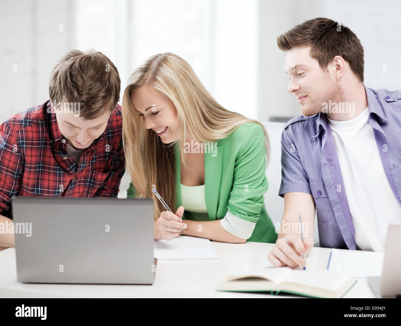 students writing something at school Stock Photo - Alamy