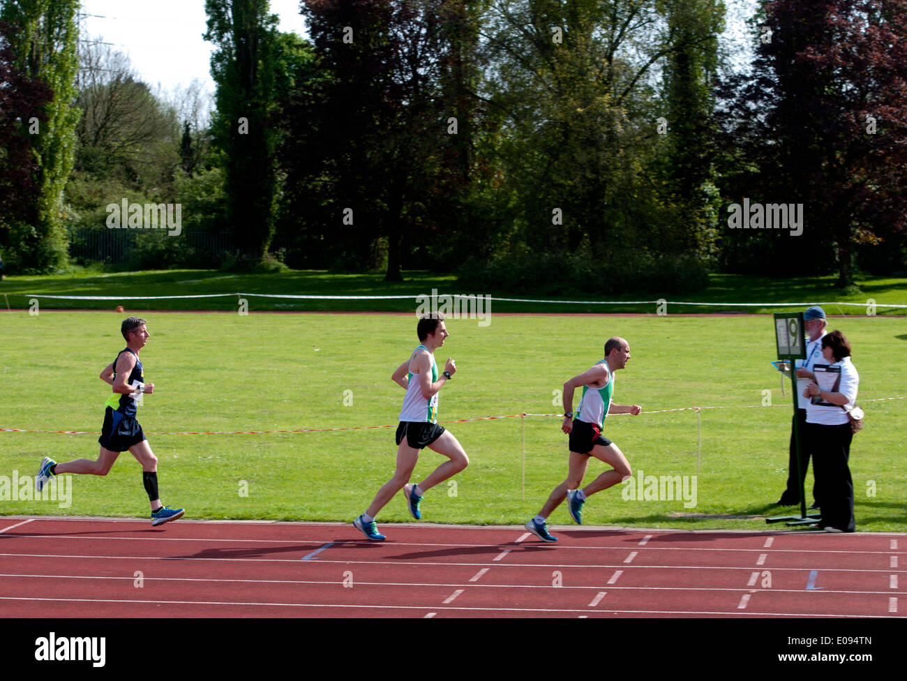 Athletics, runners in men`s 5000m race passing the lap marker Stock ...