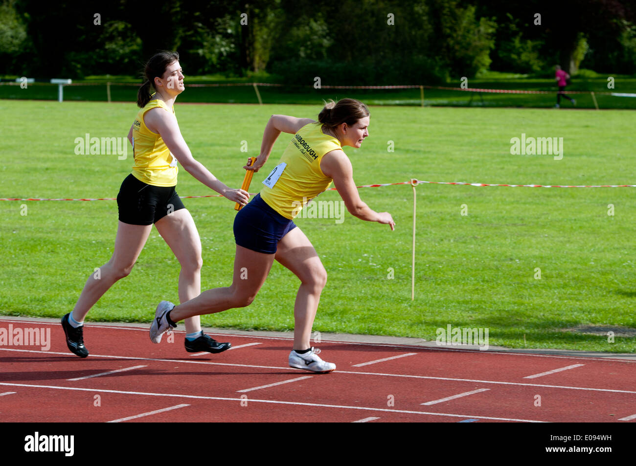 Athletics, runners passing baton in women`s 4X400m relay race at club ...