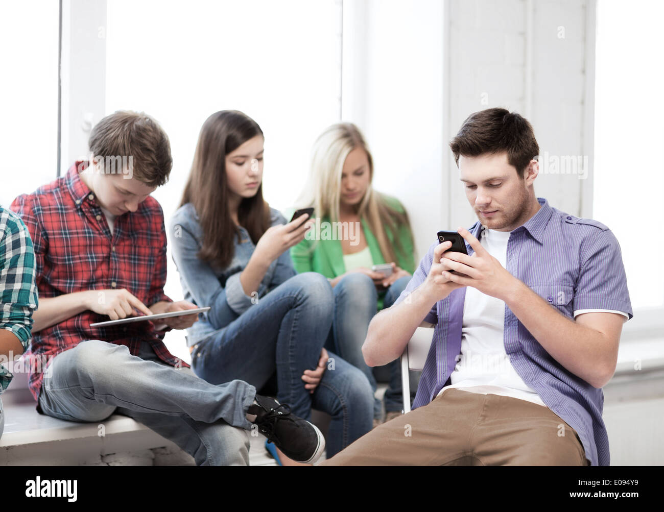 students looking into devices at school Stock Photo - Alamy