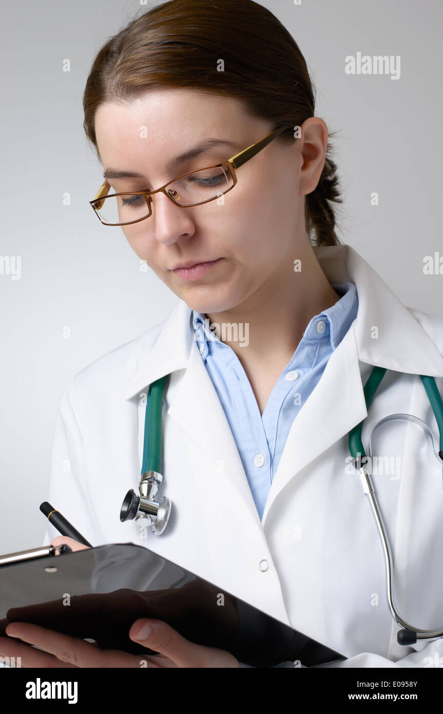 Doctor taking notes on clipboard Stock Photo - Alamy