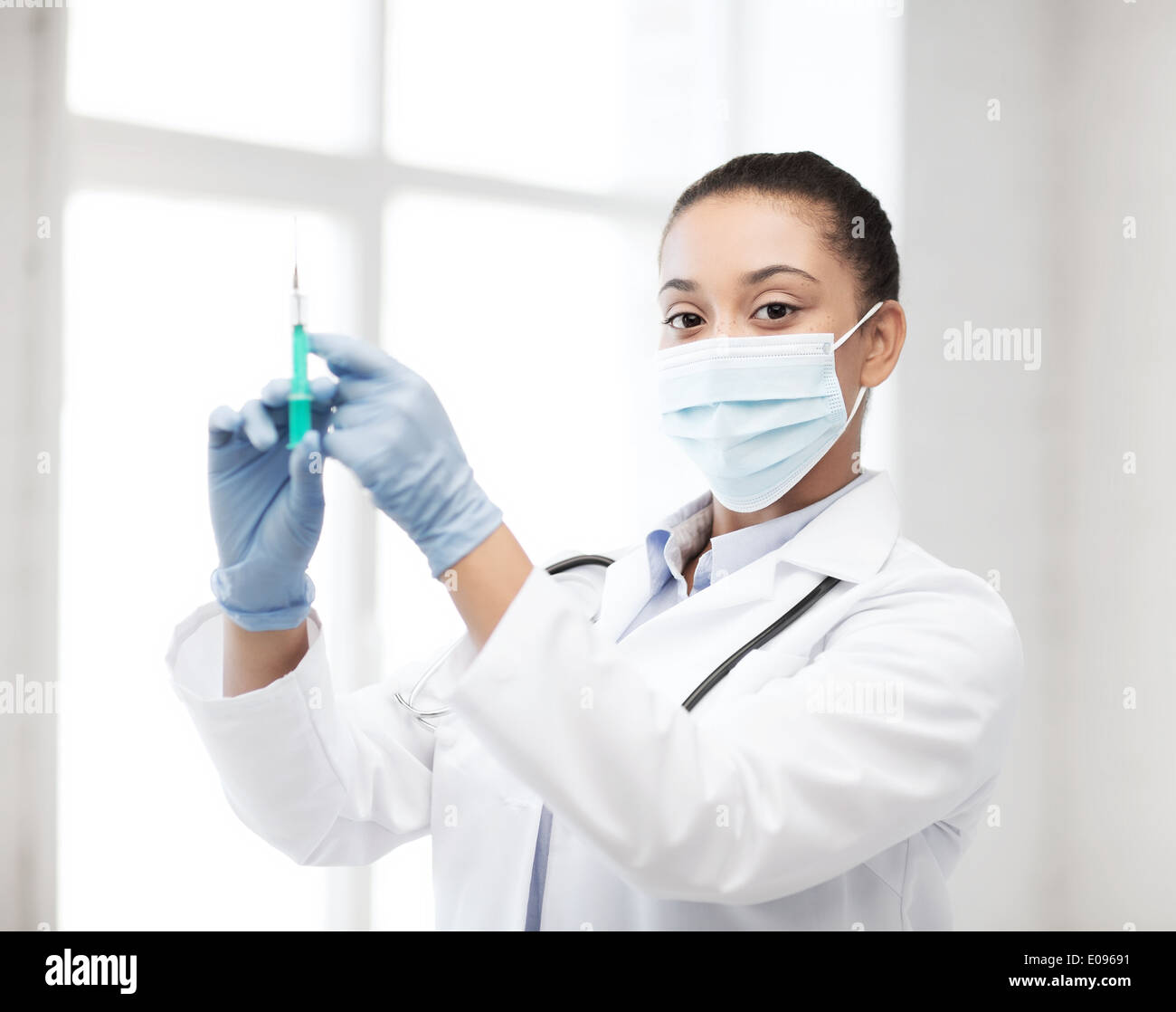 african doctor holding syringe with injection Stock Photo - Alamy