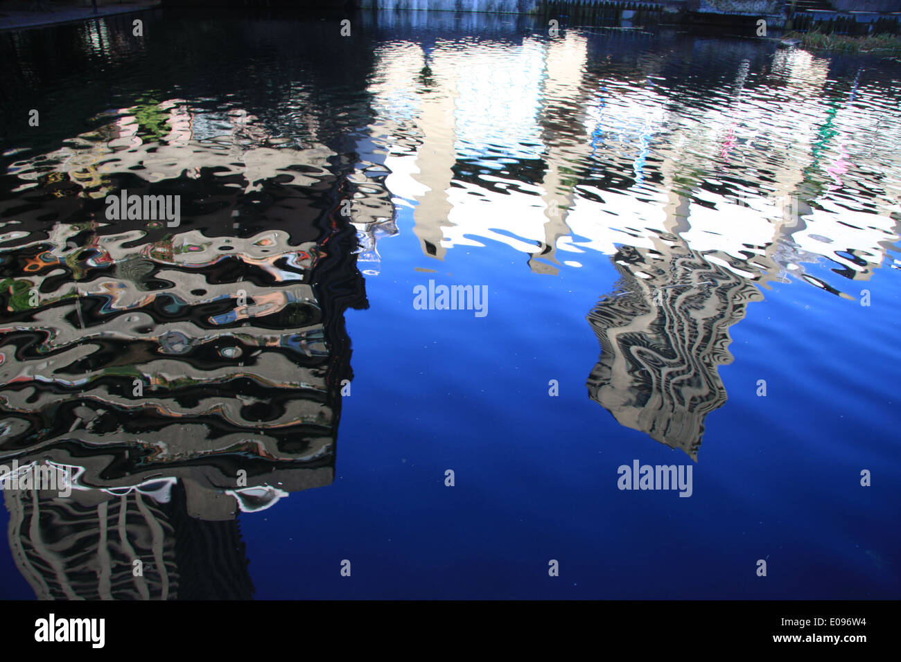 reflections of tower blocks in blue water Stock Photo - Alamy