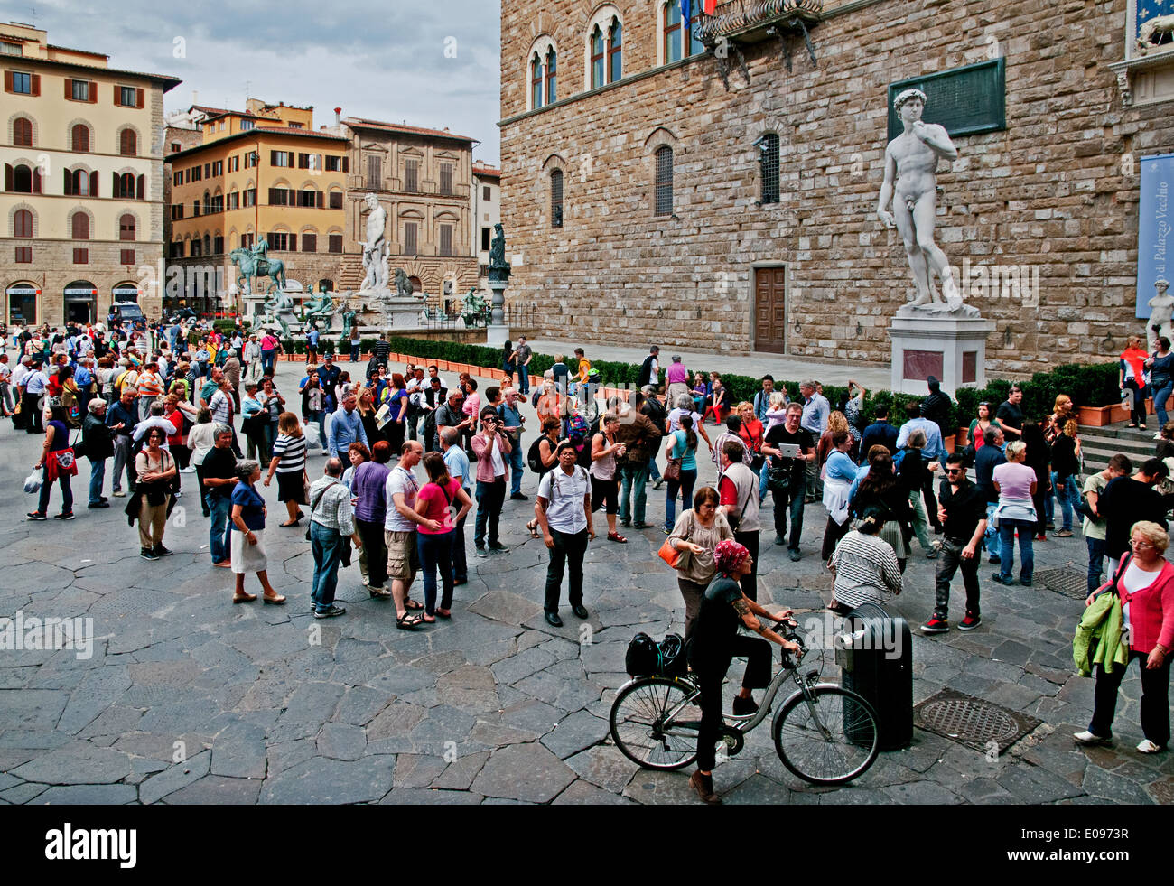 Crowds of people admiring architecture and statue of David in Piazza ...