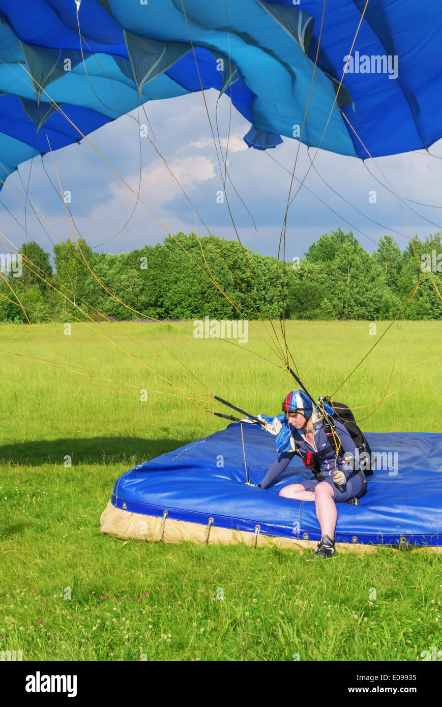 One day with parachutist in airfield. The girl skydiver lands under the ...
