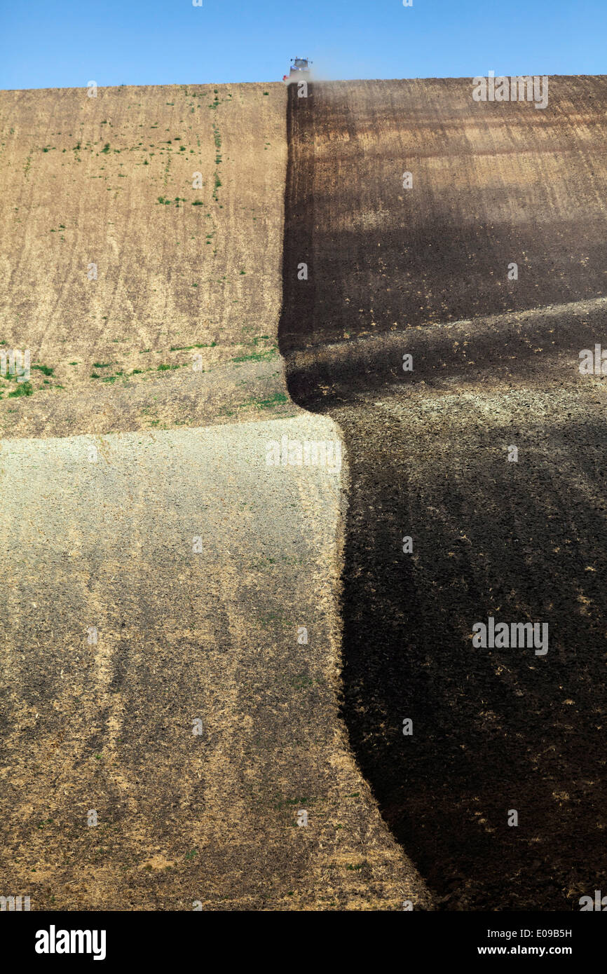 Tractor in plowed field furrows Stock Photo - Alamy