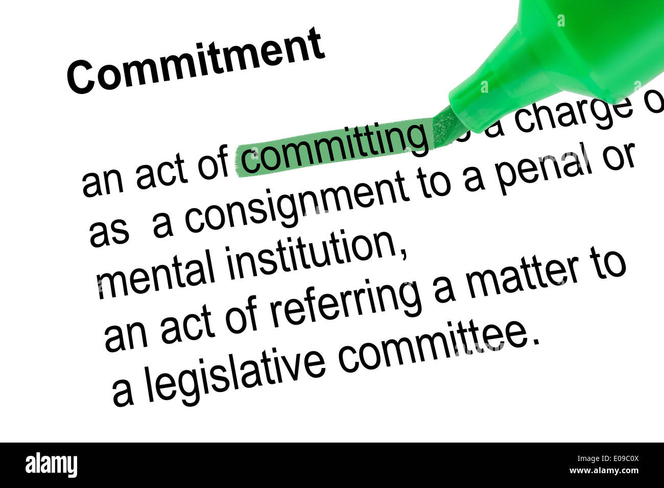 Highlighted word committing for Commitment with green pen over white ...