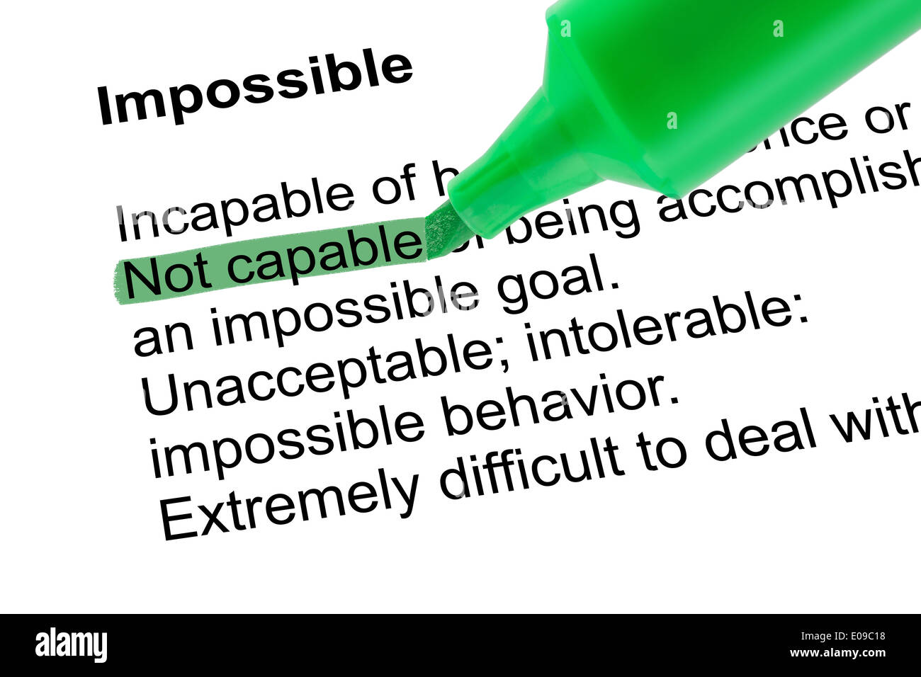 Highlighted word Not capable for Impossible with green pen over white ...