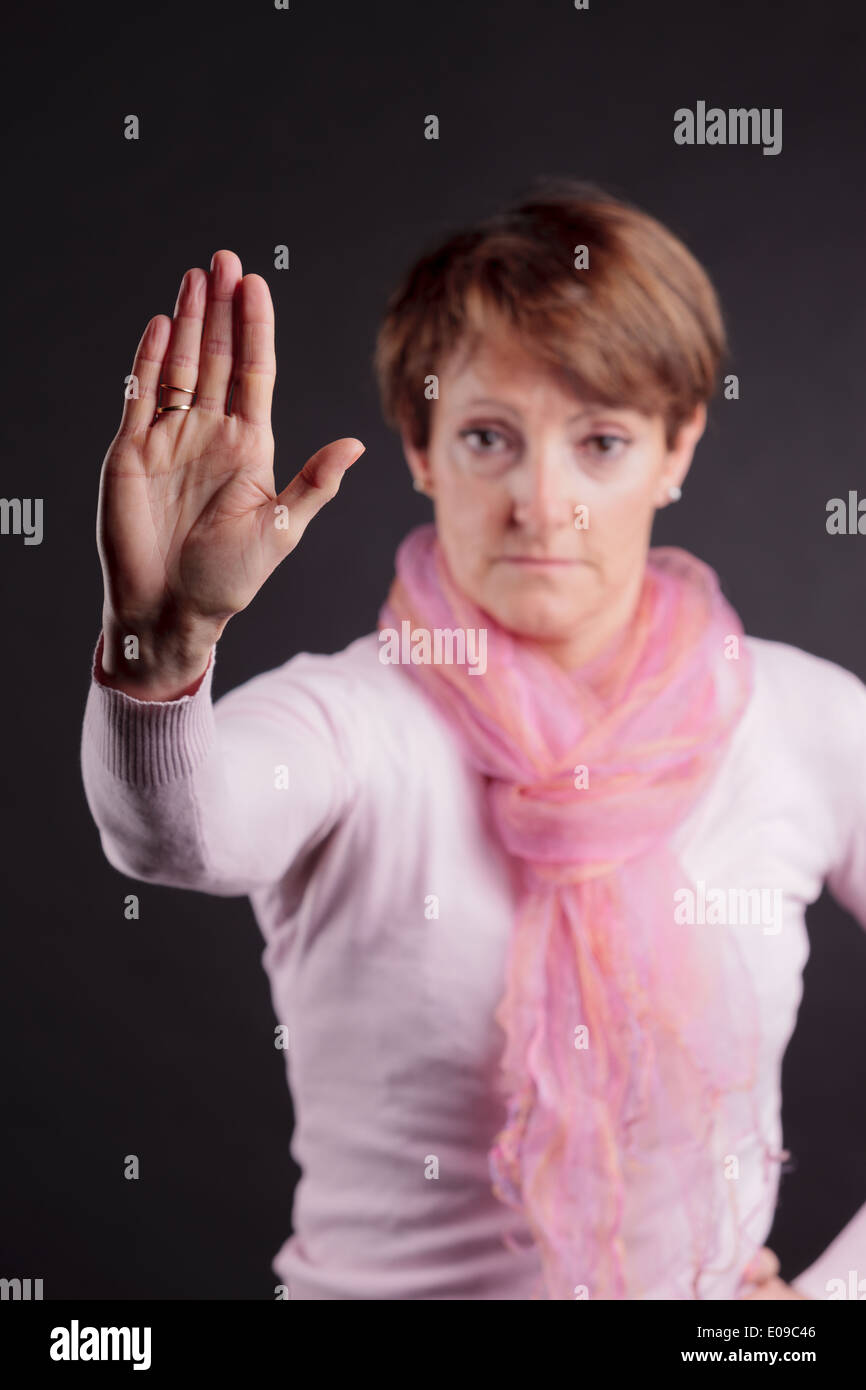 mature woman with a raised hand meaning you can't go further Stock ...