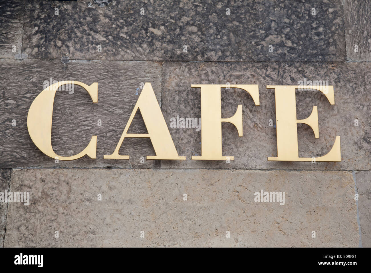 Gold Cafe Sign on Stone Wall Stock Photo - Alamy