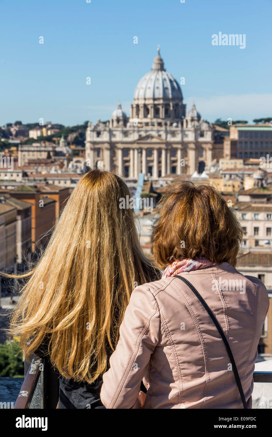Italy, Rome, Two women looking at St. Peter's Basilica from Castel Sant ...