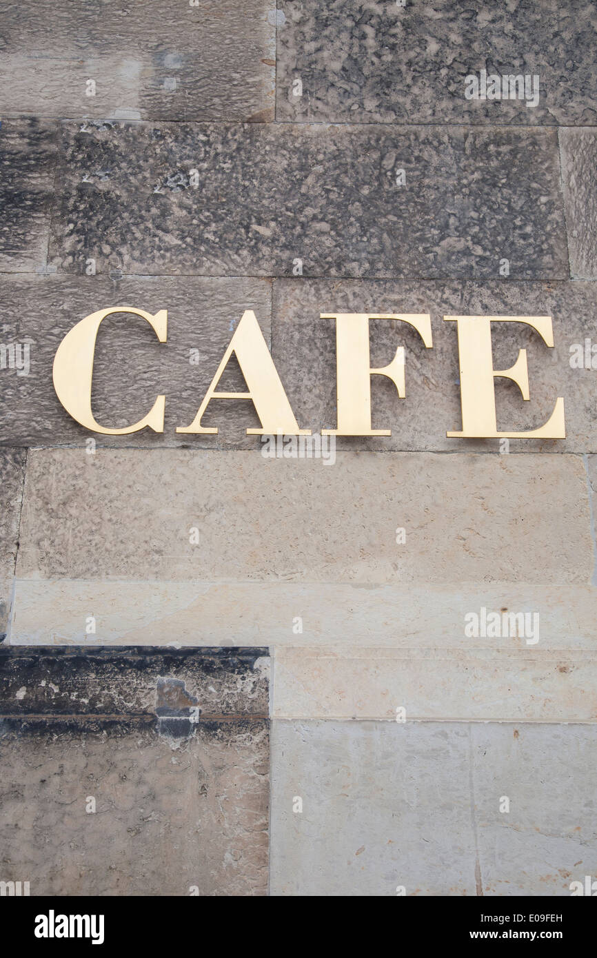 Gold Cafe Sign on Stone Wall Stock Photo - Alamy