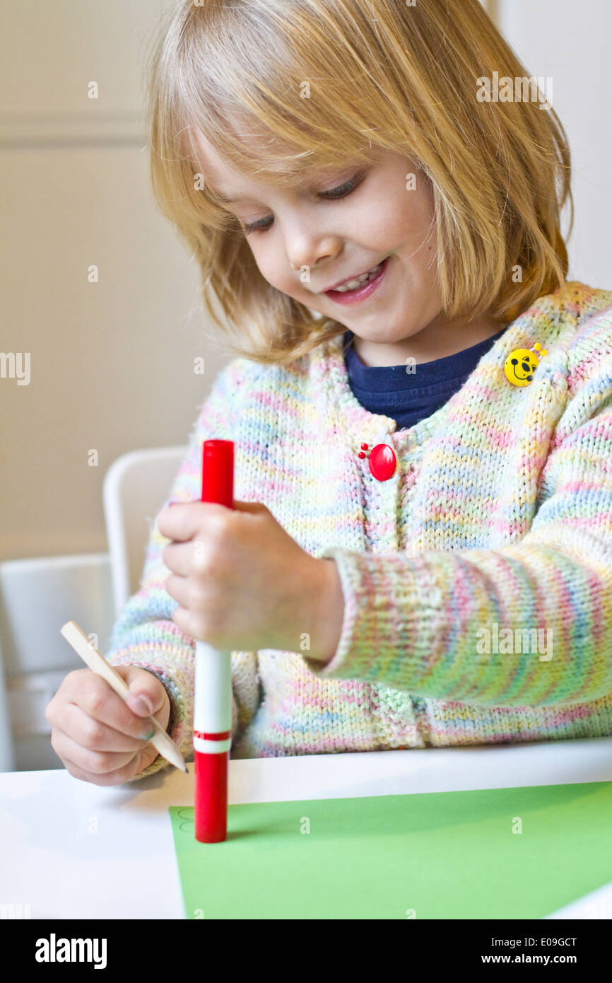 Little girl tinkering Stock Photo - Alamy
