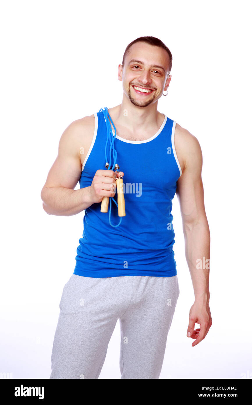 Happy sportsman standing with jumping rope over white background Stock ...
