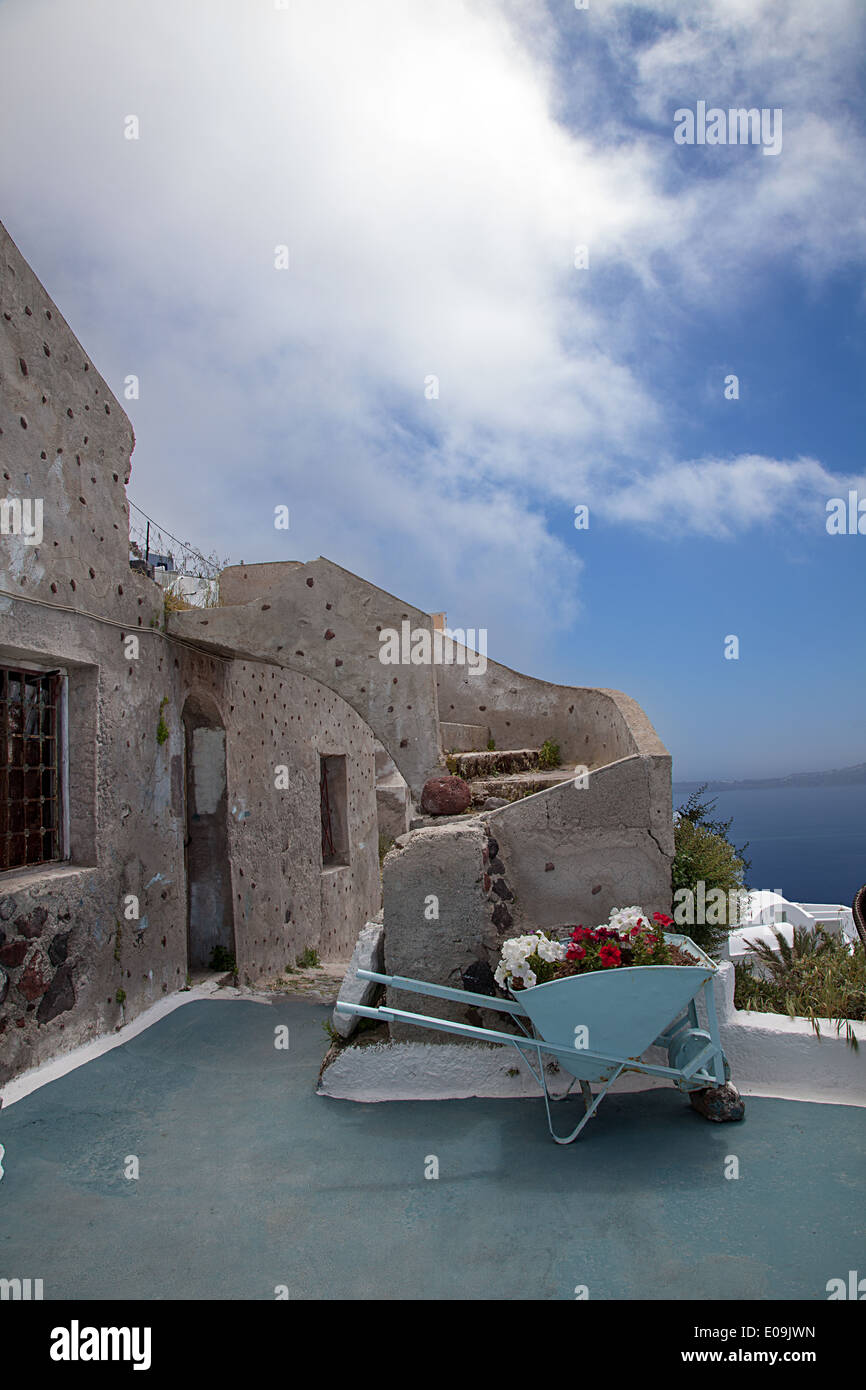Blue barrow with flowers Stock Photo - Alamy