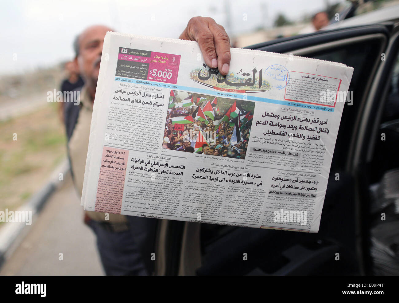 Gaza. 7th May, 2014. A Palestinian newspaper vendor shows a copy of the ...