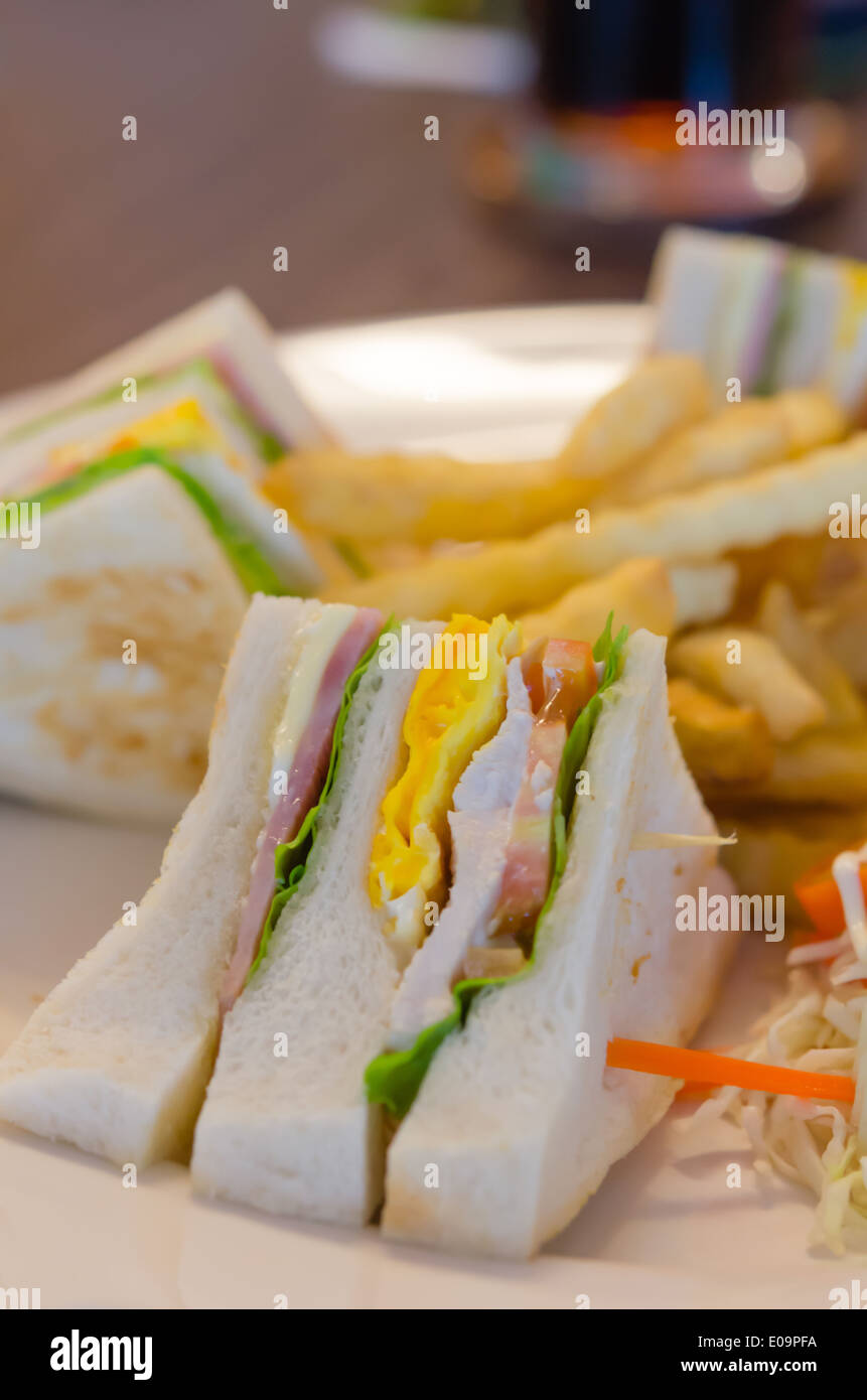 Delicious club sandwich with french fries at a dinner Stock Photo - Alamy