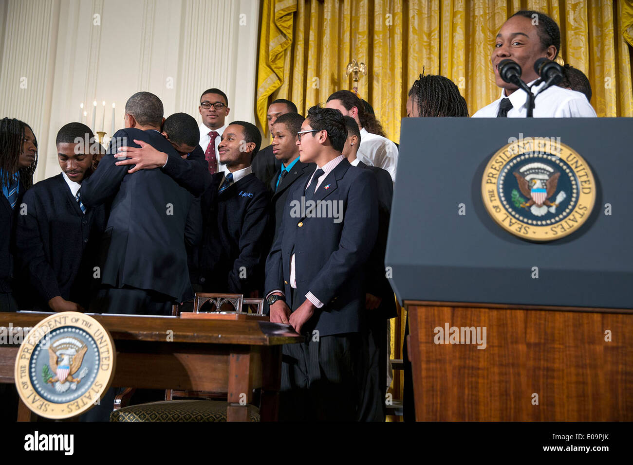 US President Barack Obama hugs a participant after signing a ...