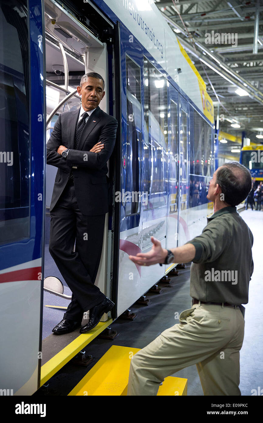 US President Barack Obama stands in the doorway of a new light rail car ...