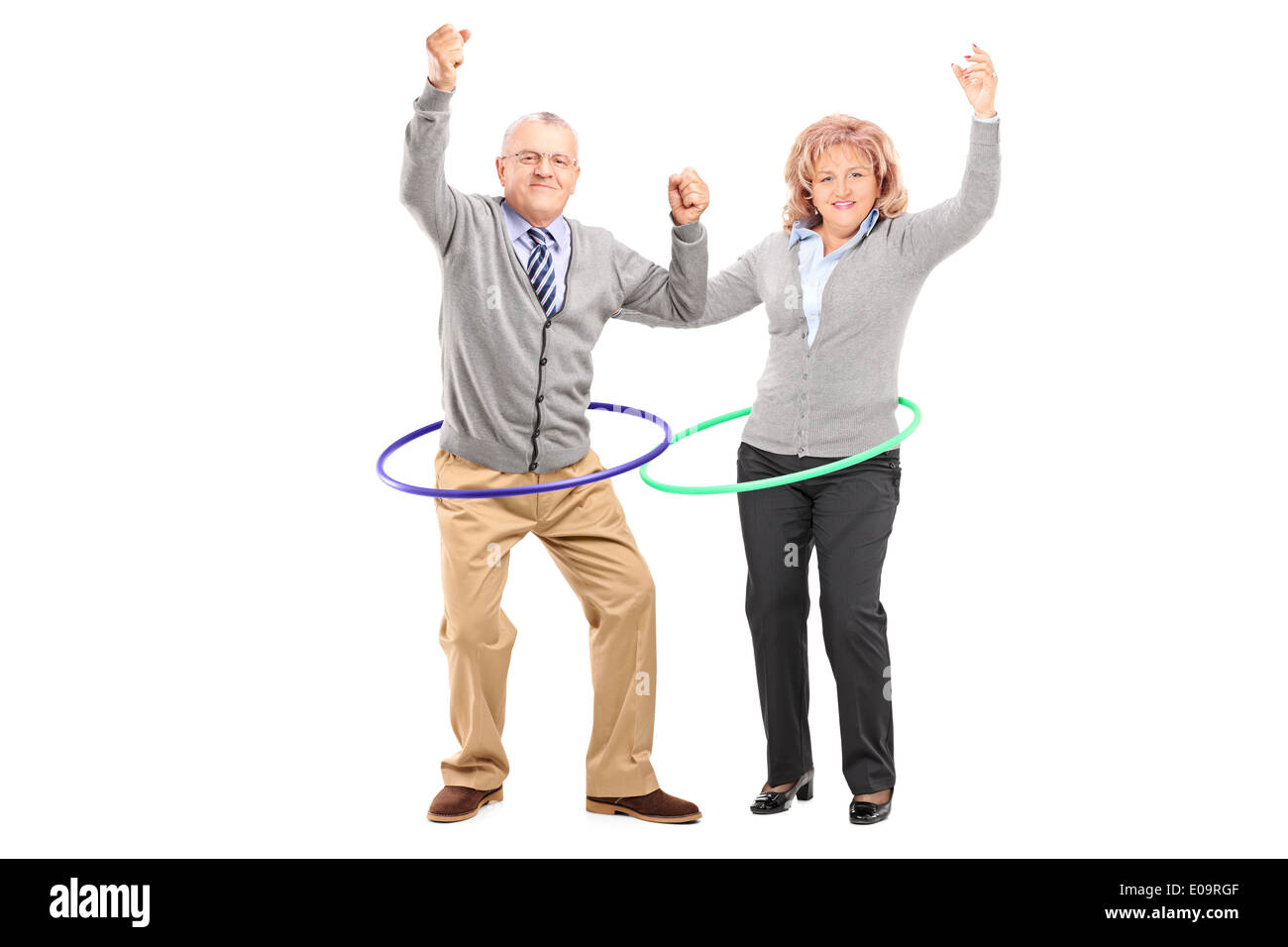 Mature man and woman exercising with hula hoop Stock Photo - Alamy