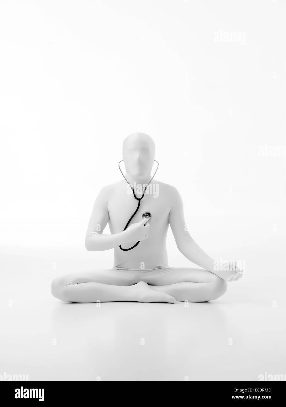 faceless man dressed white with stethoscope in his ears listening to ...