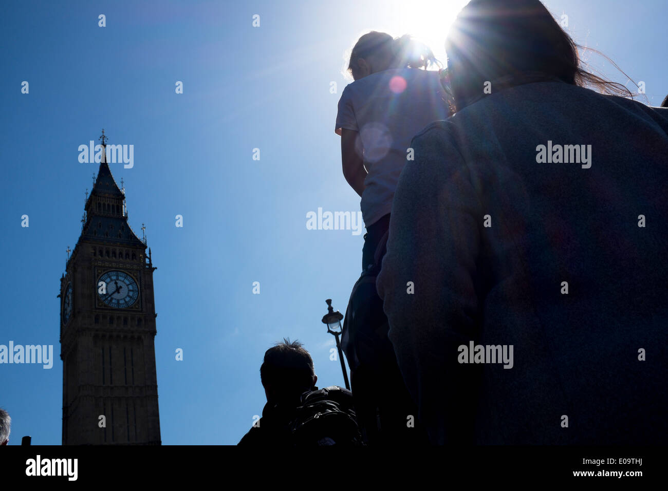 Child on her father's shoulders in front of Big Ben at the Houses of ...