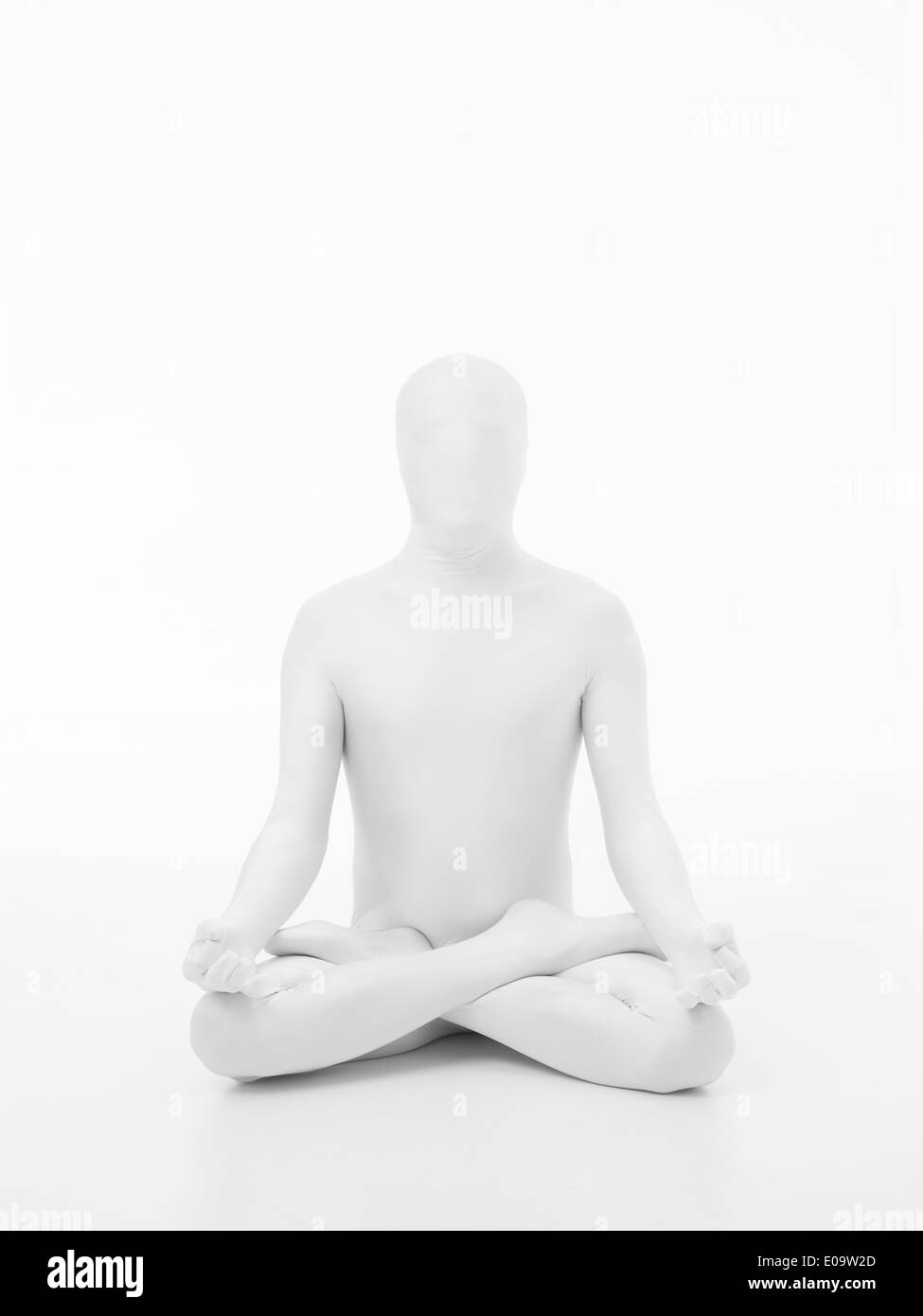 faceless man dressed in white sitting in yoga lotus position, front ...