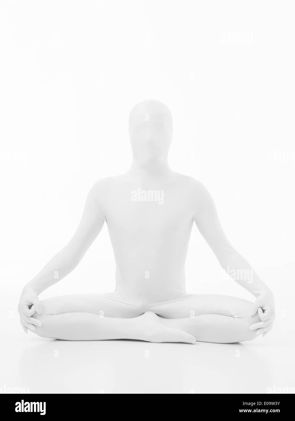 faceless man dressed in white sitting in yoga lotus position, front ...