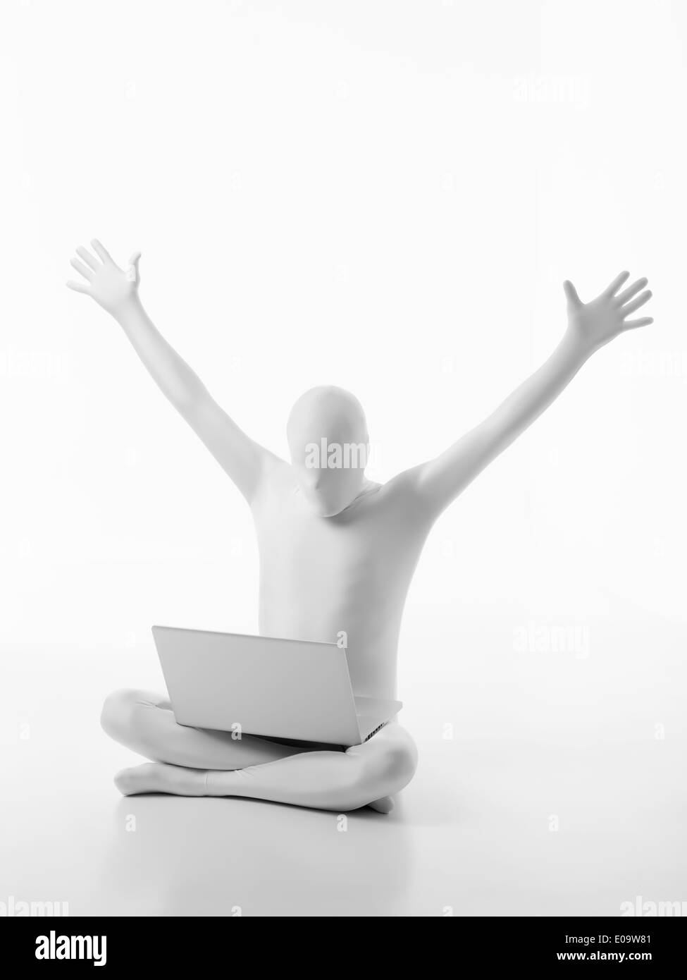 faceless man dressed white sitting with a laptop in lap hands wide open ...