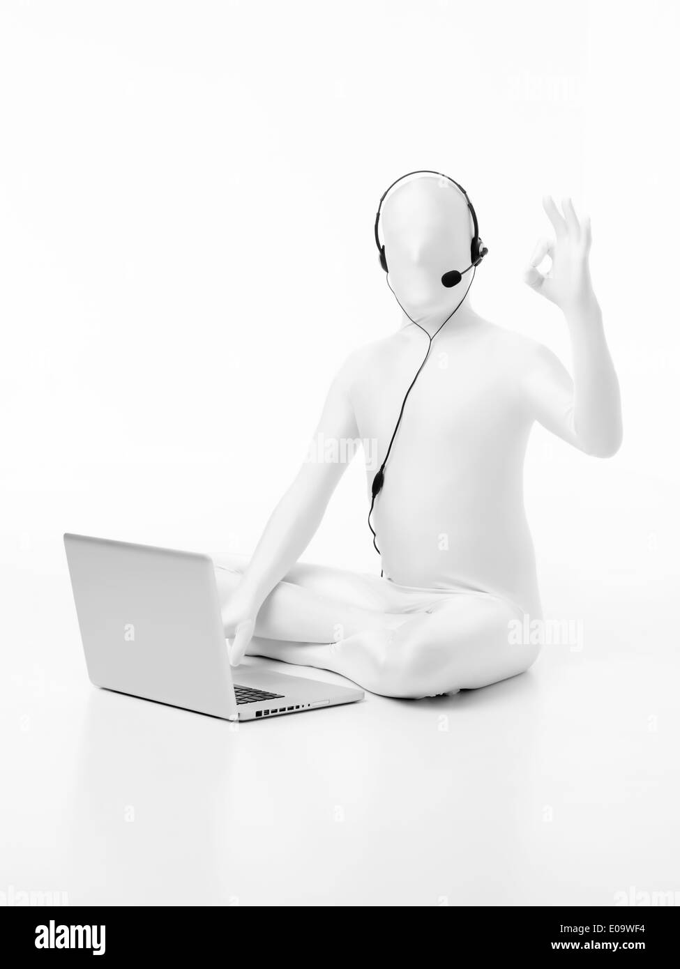 faceless man dressed white sitting with a laptop in lap head Headset ok ...