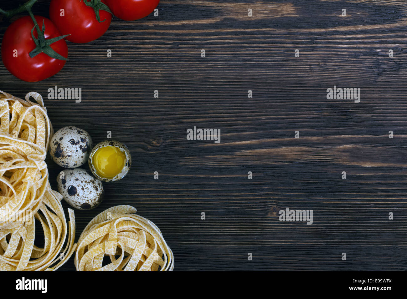Overhead view of ingredients for an Italian pasta recipe on rustic wood ...