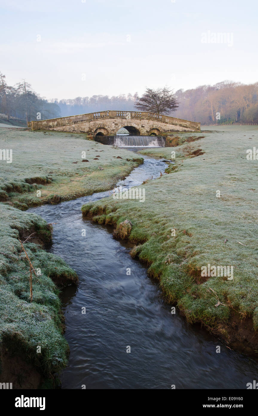A view of the arched bridge over the beck that runs through Hovingham ...