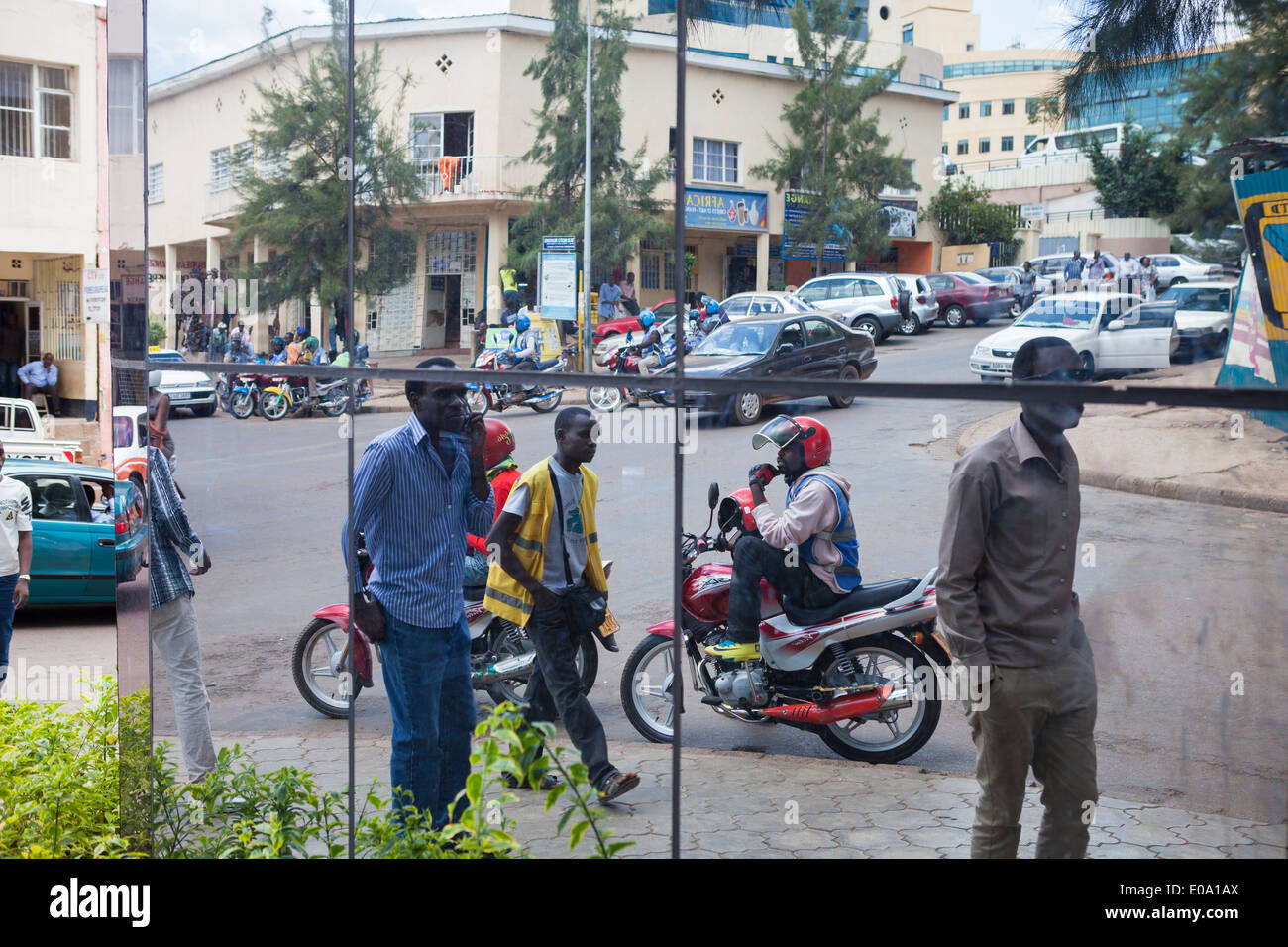Street scene in downtown Kigali reflected on modern building, Rwanda ...