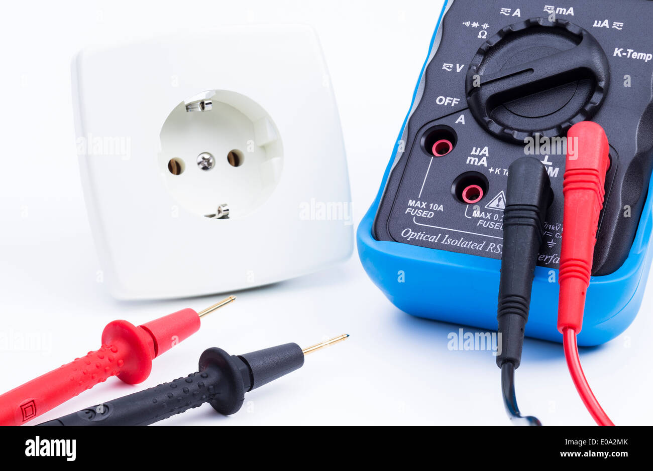 The image shows a plug socket and a multimeter, isolated on white ...