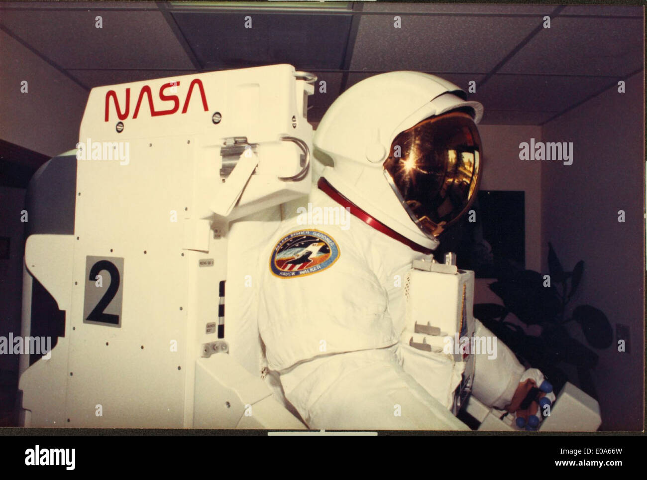 This glossy photo features a NASA space suit, a key component of ...