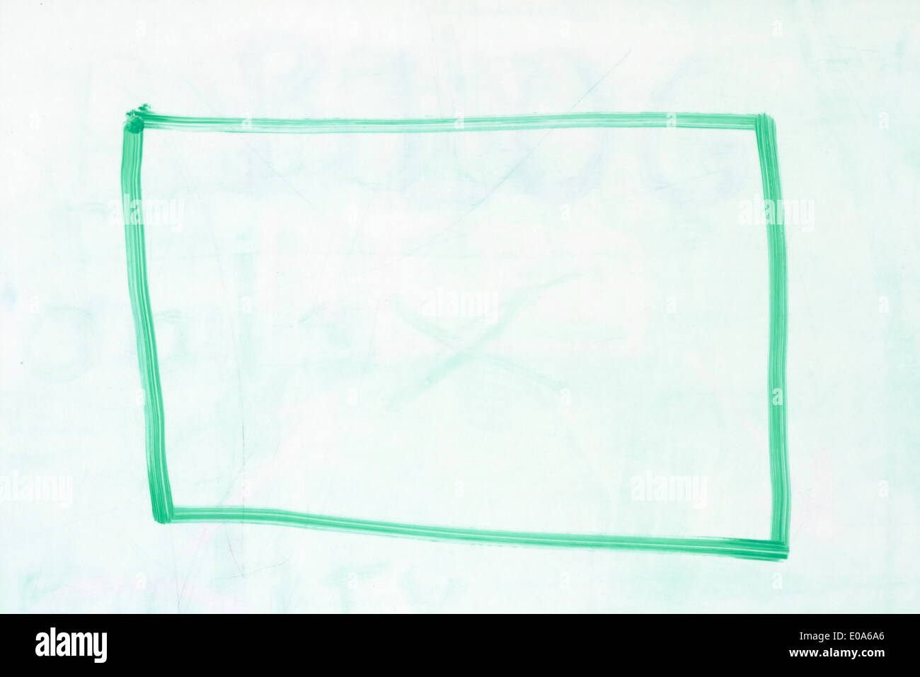 rectangular box outline in green dry erase marker on a used white board ...