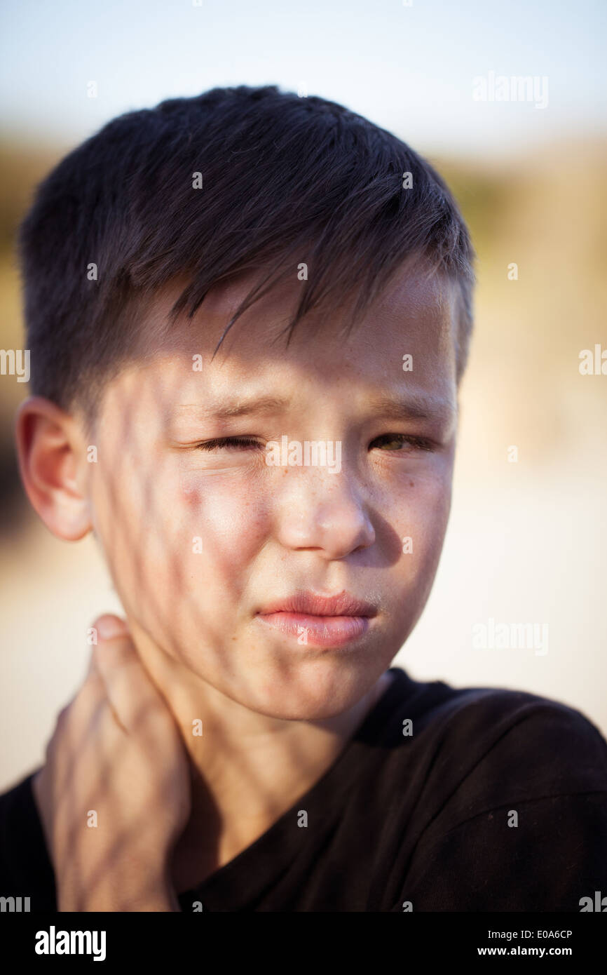 Close up portrait of squinting boy Stock Photo - Alamy