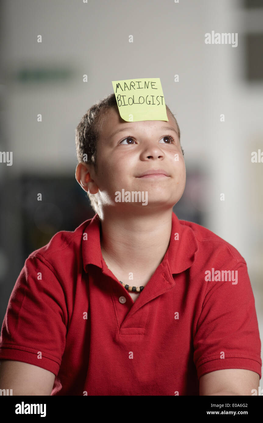 Portrait of boy with sticky note on forehead Stock Photo - Alamy