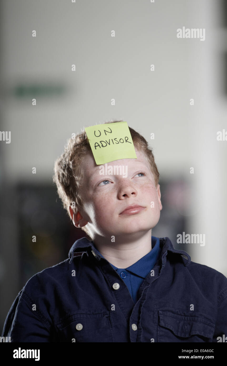 Portrait of boy with sticky note on forehead Stock Photo - Alamy