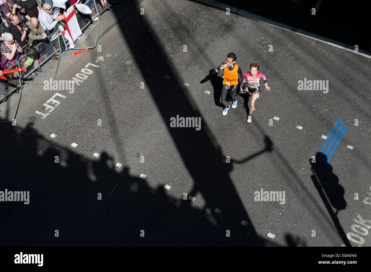 Competitors in the 2014 London Marathon. Visually impaired runner and ...