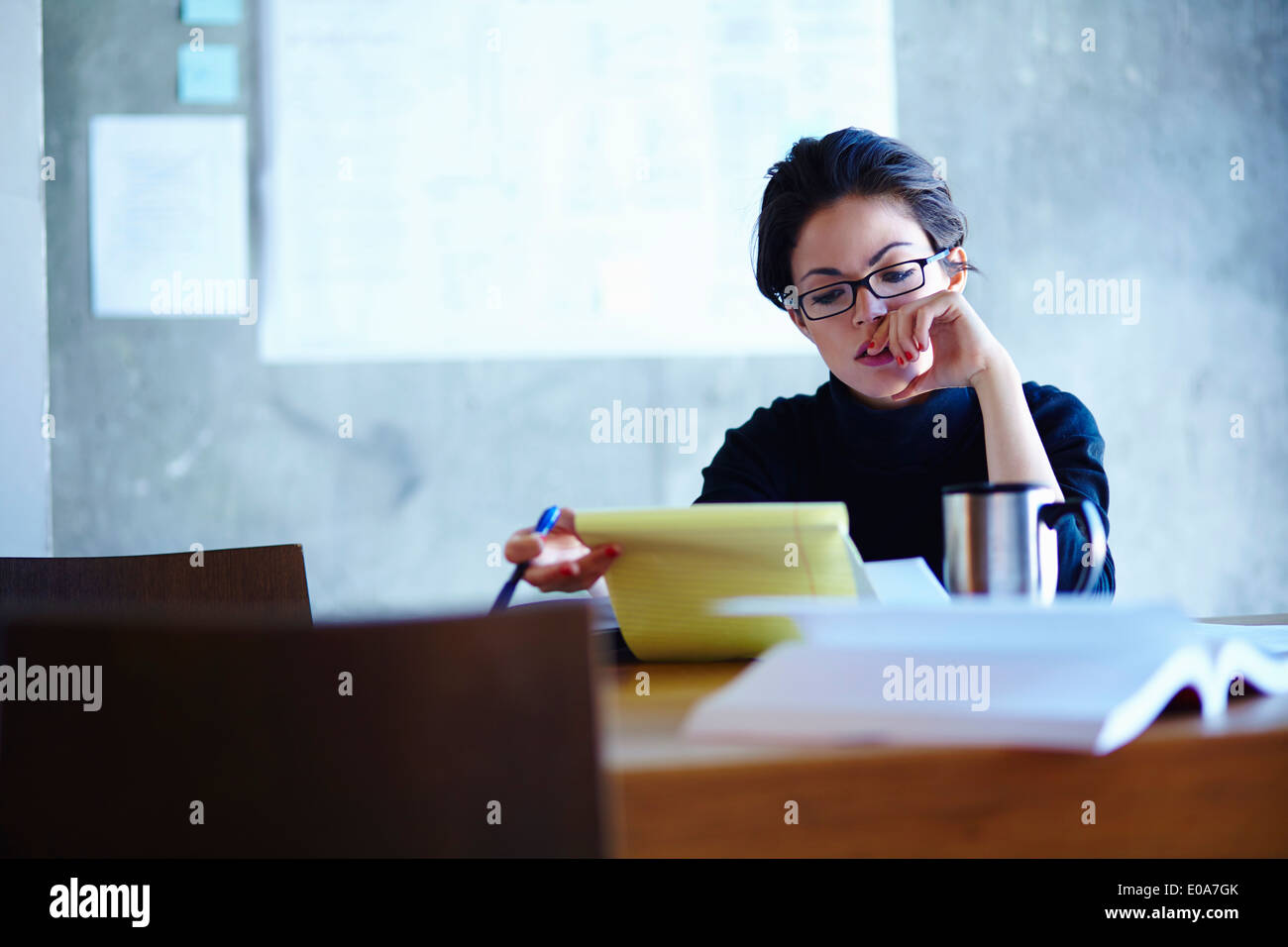 Young businesswomen studying paperwork in office Stock Photo - Alamy