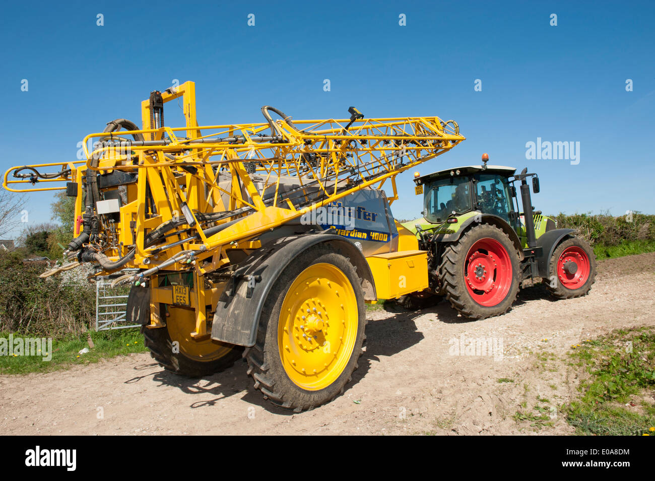 Farm crop sprayer being towed behind tractor Stock Photo - Alamy