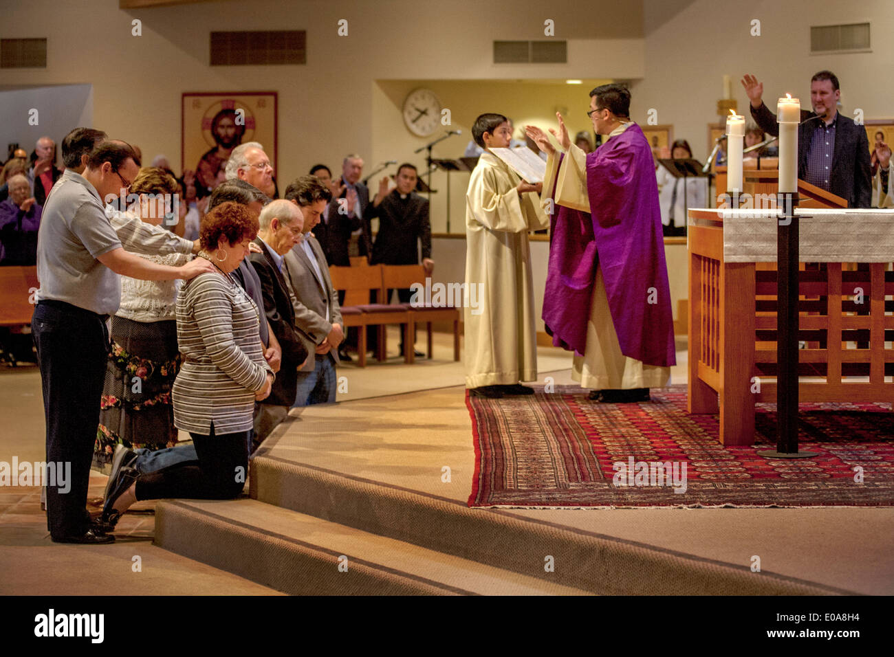 Catechumens, or people wishing to become Catholics, kneel with their ...