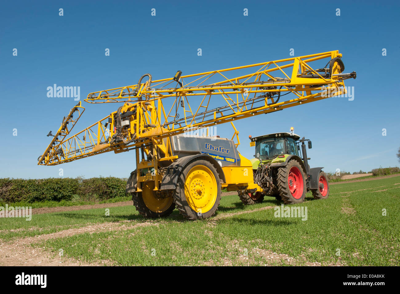Farm crop sprayer being towed behind tractor Stock Photo - Alamy