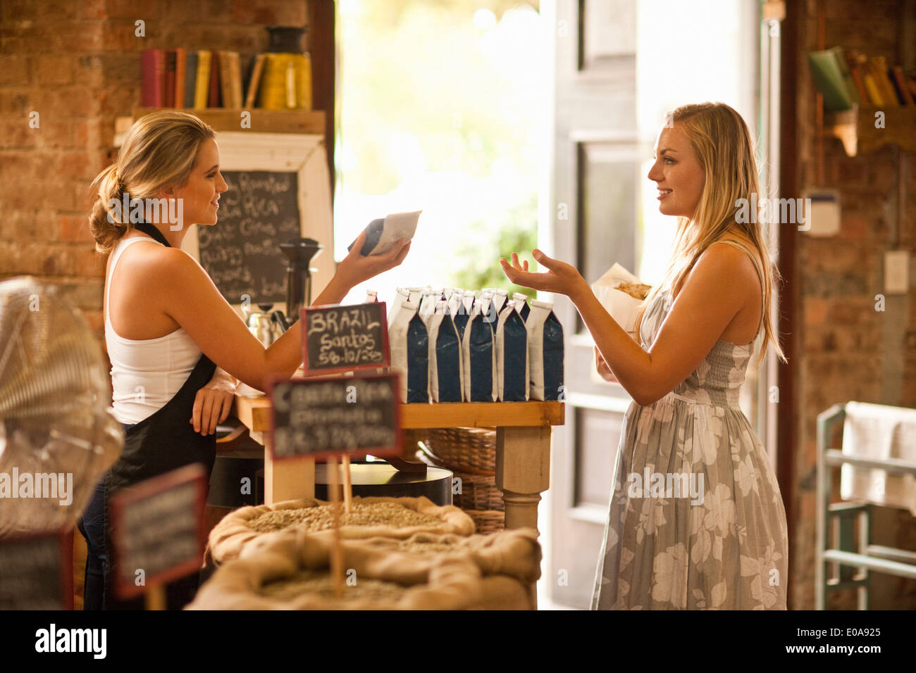 Woman serving customer hi-res stock photography and images - Alamy