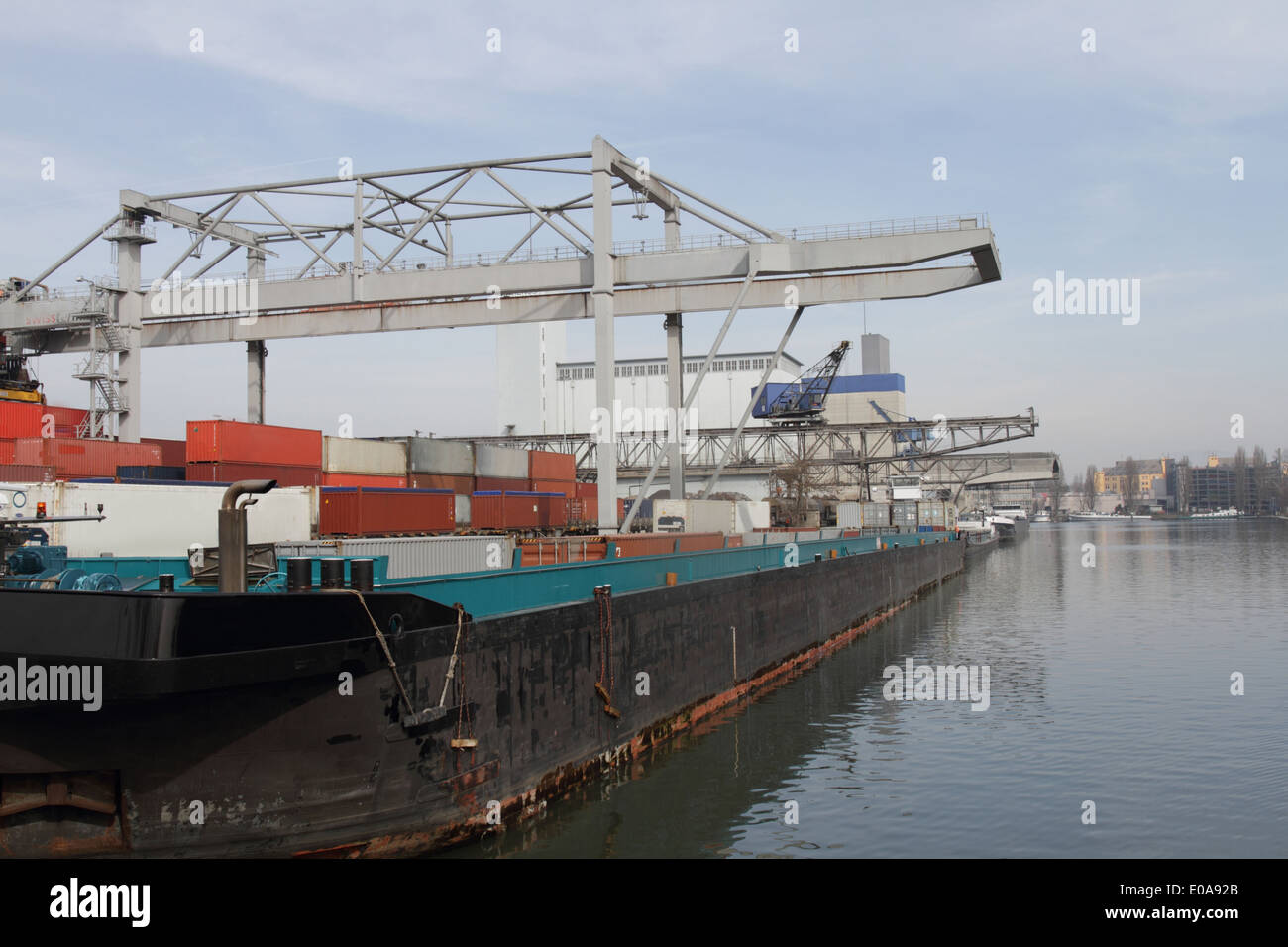 Container crane and freight containers in river port Stock Photo - Alamy