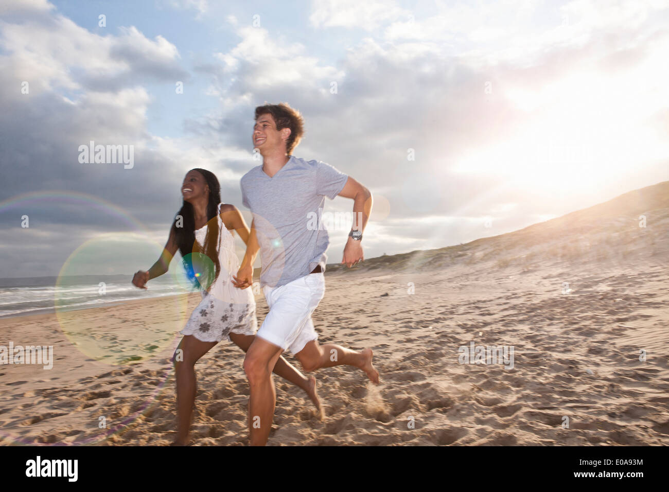Couple running on beach hi-res stock photography and images - Alamy