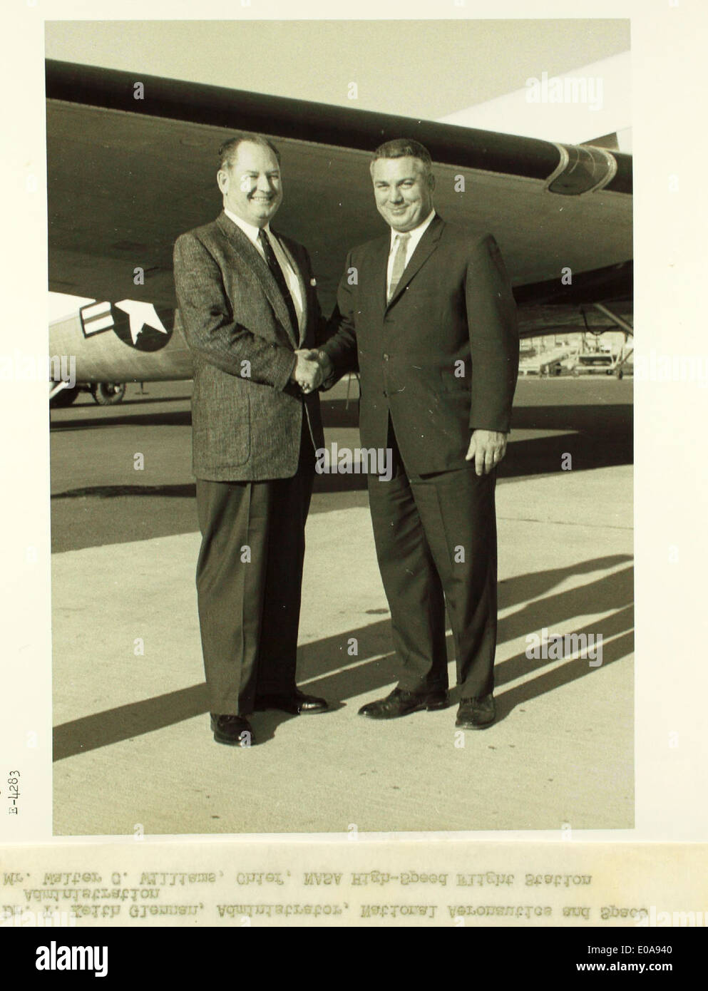 This glossy photo features NASA personnel, likely from the early stages ...