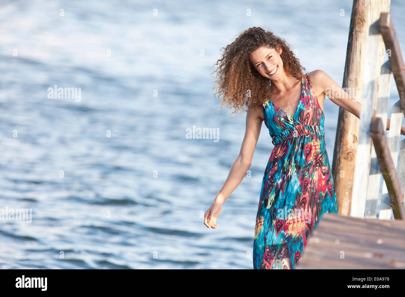 Smiling young woman jetty lake hi-res stock photography and images - Alamy