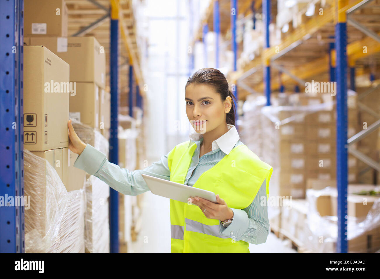 Female warehouse worker with digital tablet Stock Photo - Alamy